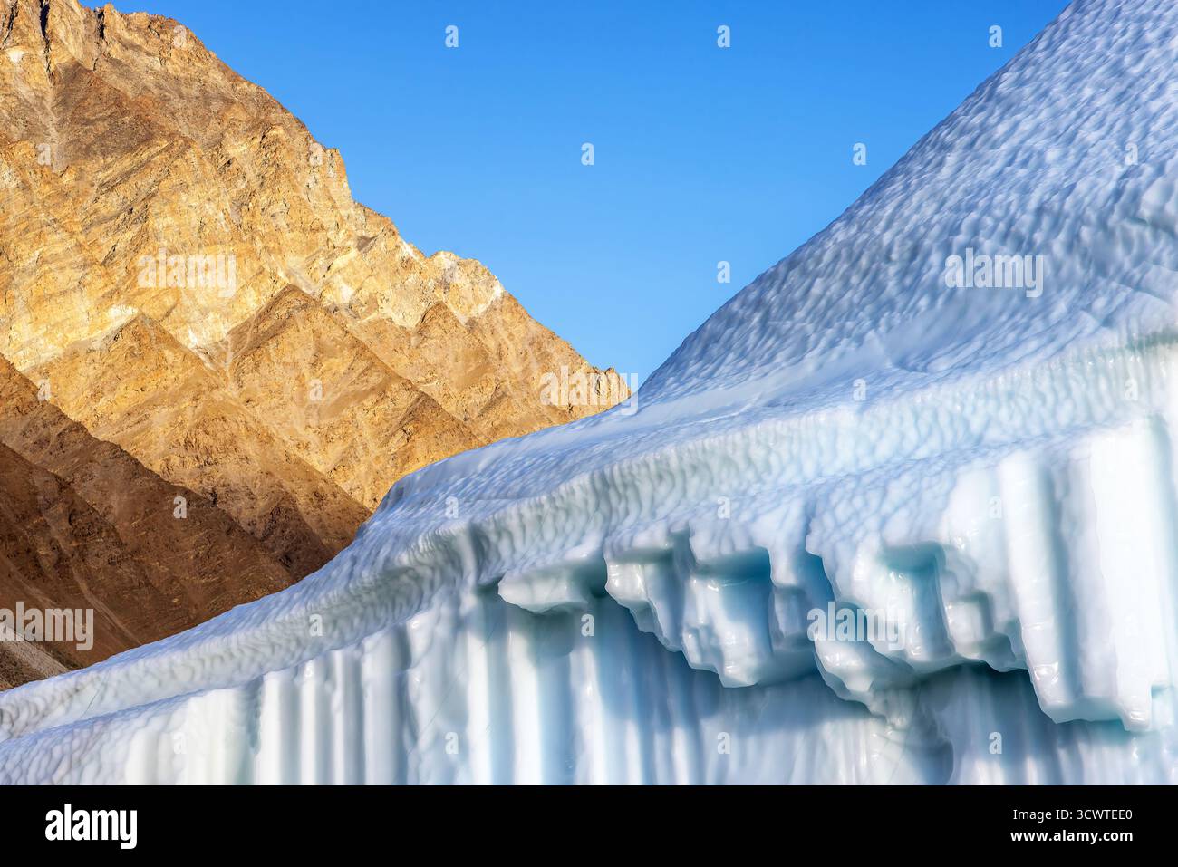 Arctic layers of a giant iceberg, mountainside and blue sky, abstract ...