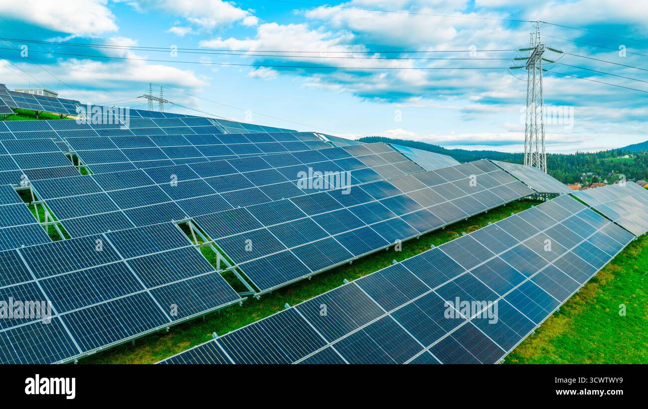 Large solar power station on hillside with metal structures and blue ...
