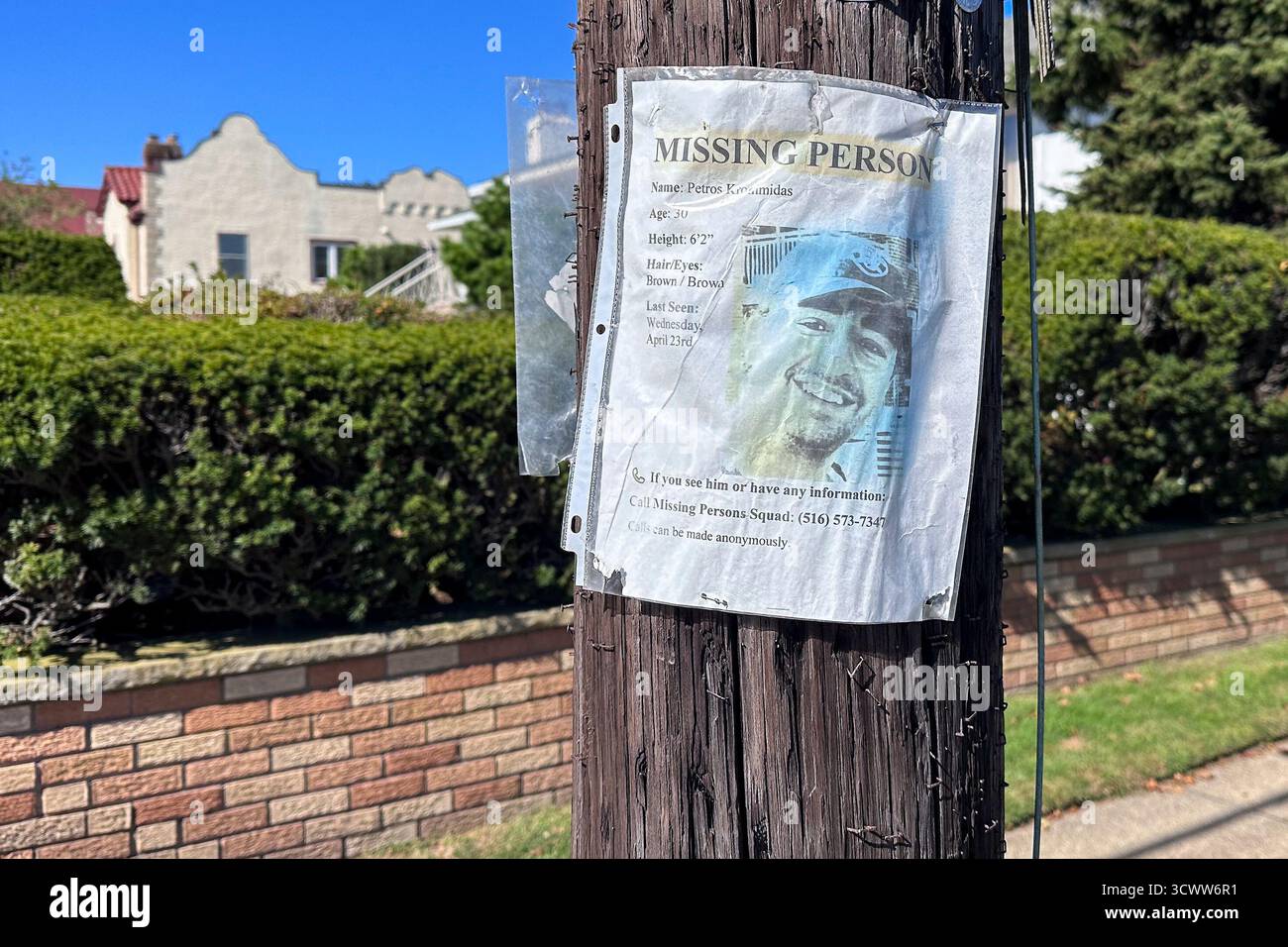 A missing person flyer for Petros Krommidas hangs on a telephone pole ...