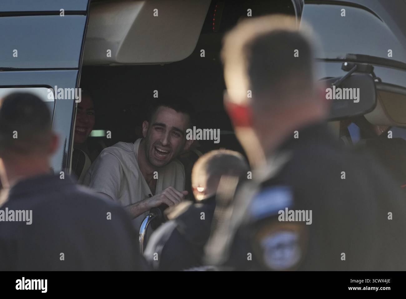 Freed Israeli hostage Avinatan Or gestures from a van as he arrives at ...