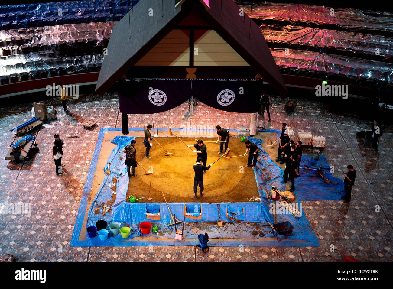 The soil is smoothed during the construction of the dohyo in the ...