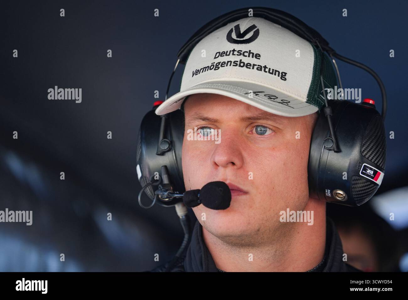 Race driver Mick Schumacher watches from the pit area as he ...