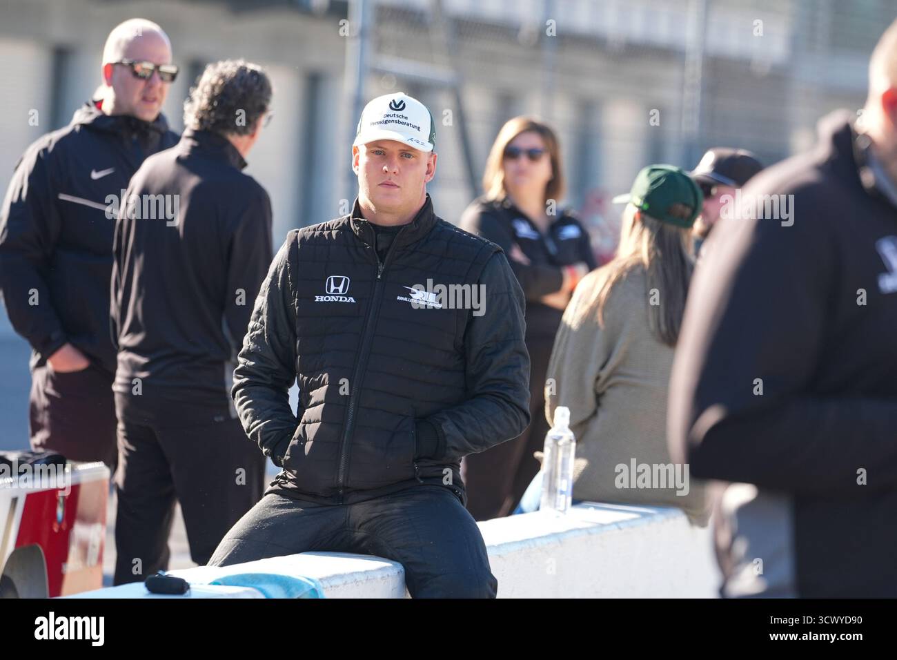 Race driver Mick Schumacher watches from the pit area as he ...