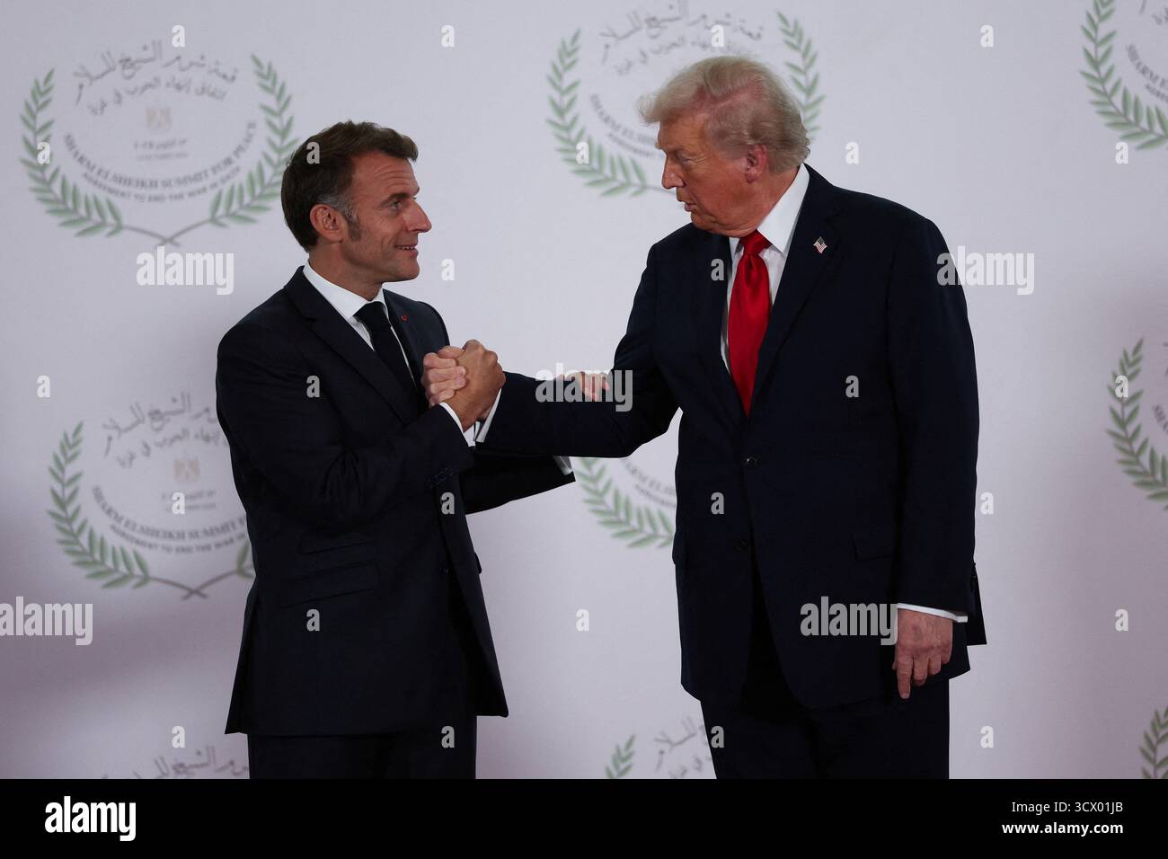 US President Donald Trump and French President Emmanuel Macron shake ...