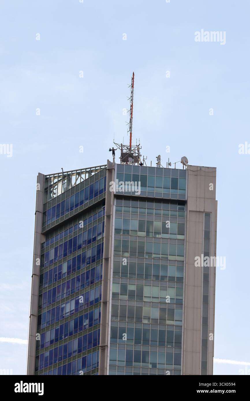 A BASE jumper glides past the City Tower skyscraper at sunrise ...