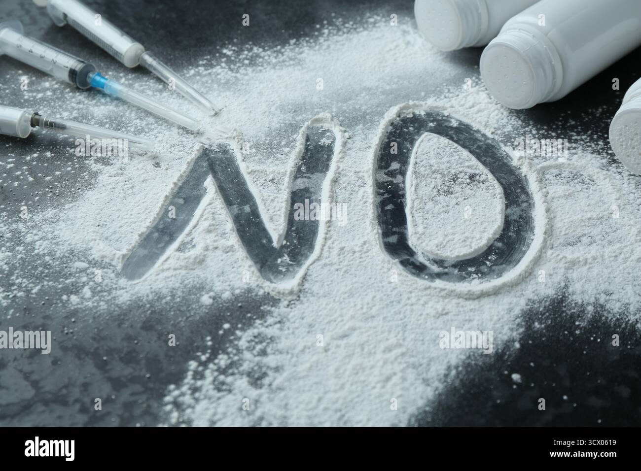 Word NO made of talcum powder, containers and syringes on black ...