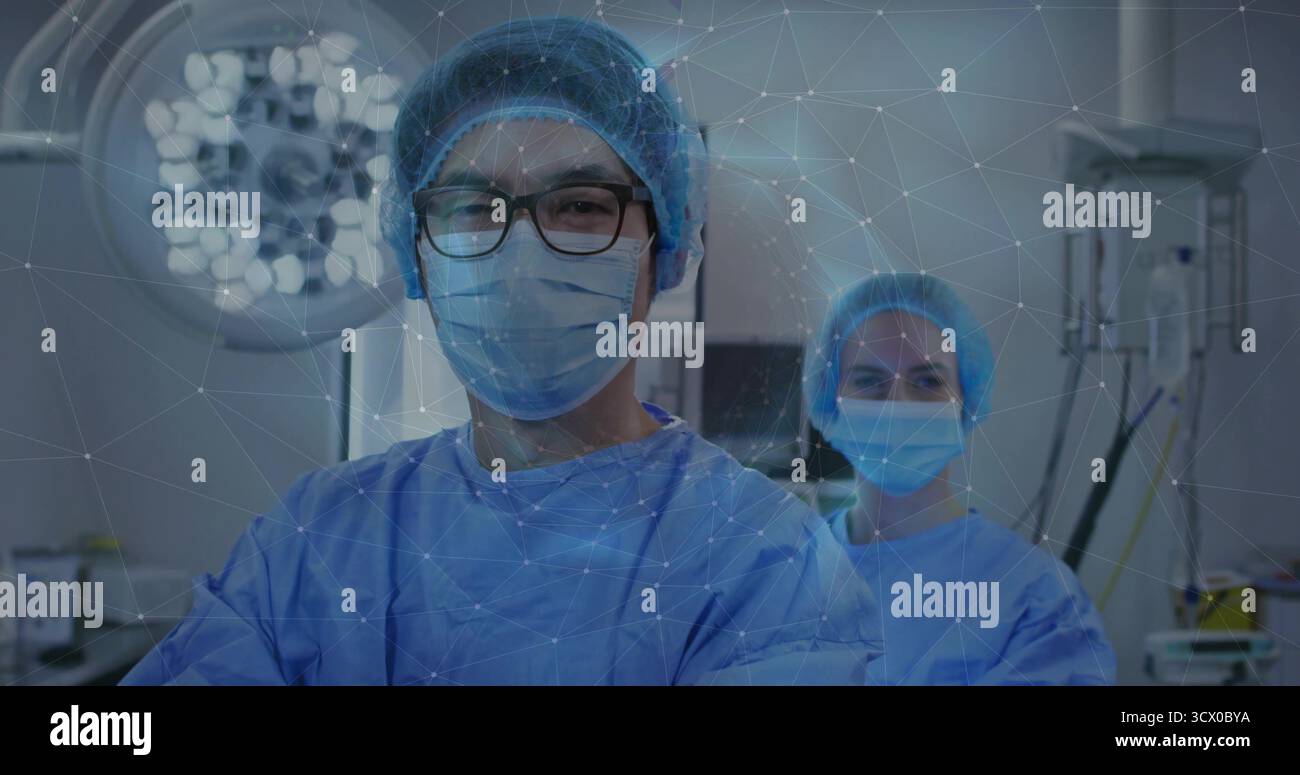Operating surgeon wearing surgical attire in OR with overhead light ...