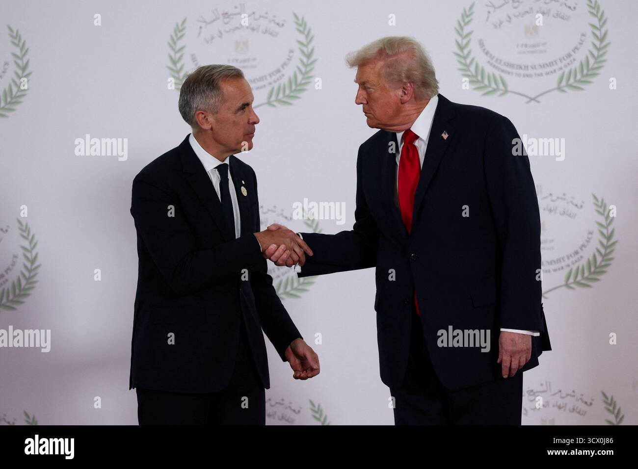 Canadian Prime Minister Mark Carney and US President Donald Trump shake ...