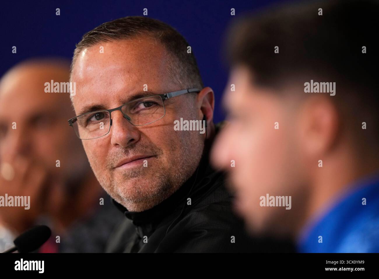 Israel coach Ran Ben Simon attends a news conference flanked by Israel ...
