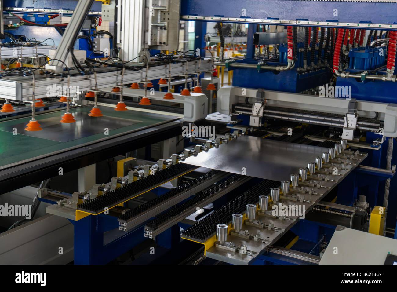 A modern automated stamping machine on a refrigerator production line ...