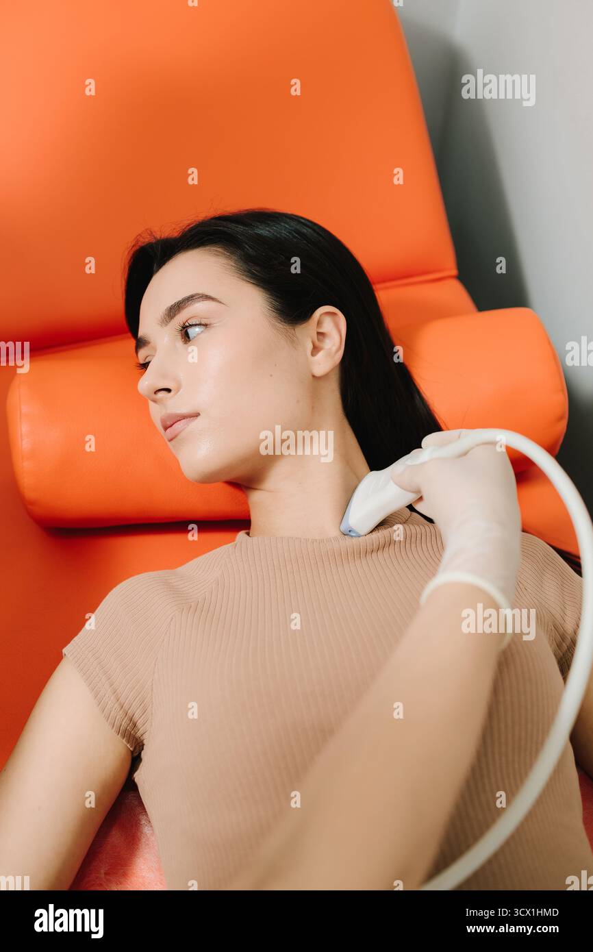 Girl undergoes an ultrasound test as the probe captures internal ...