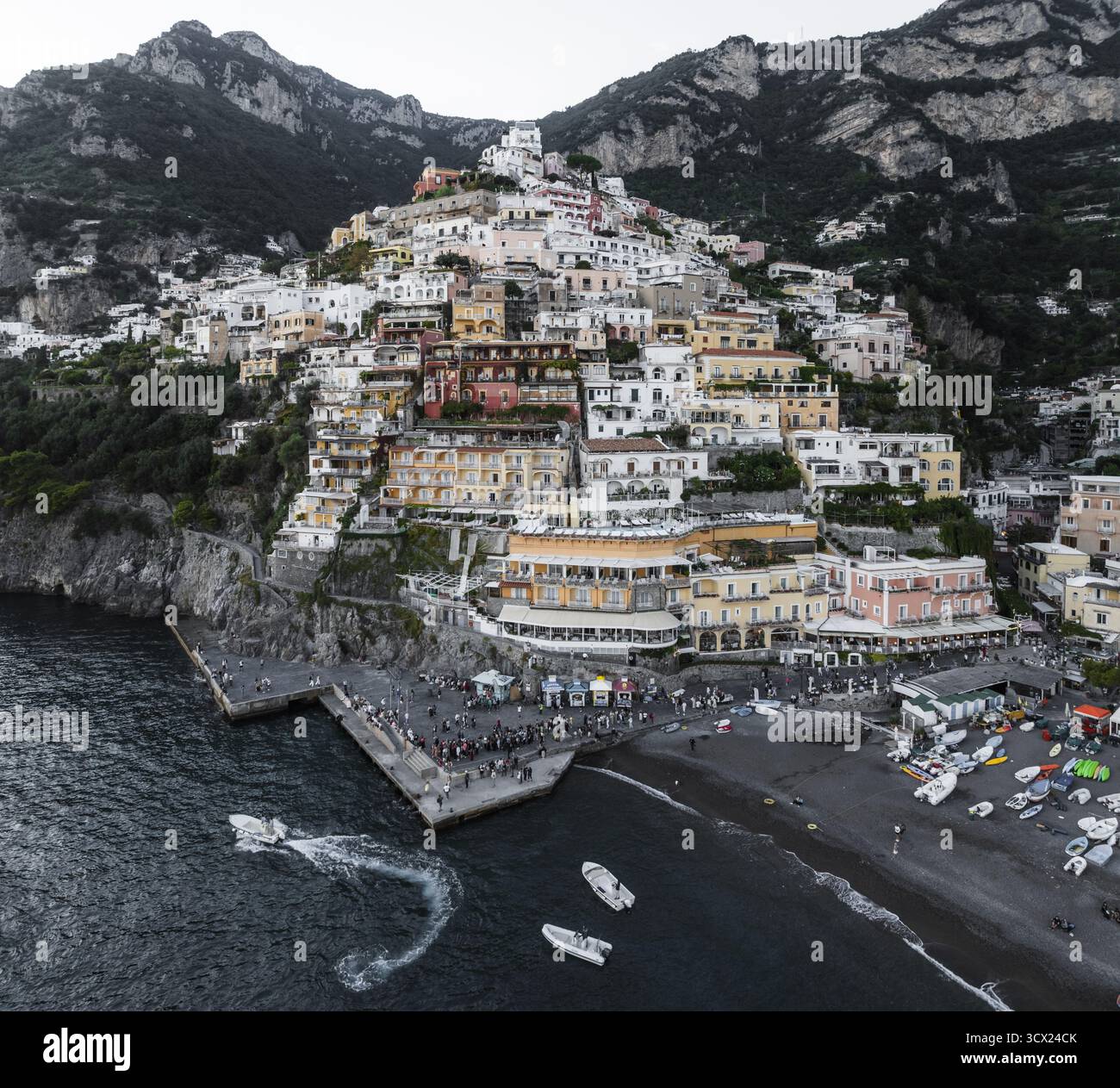 Aerial view of pastel buildings cascading down the cliffs towards the ...