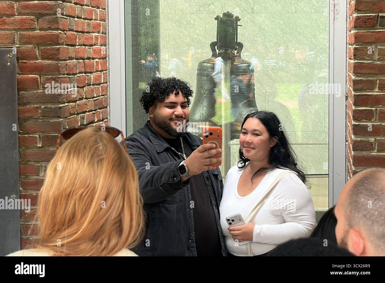 Visitors line up to view the Liberty Bell through a window of the ...