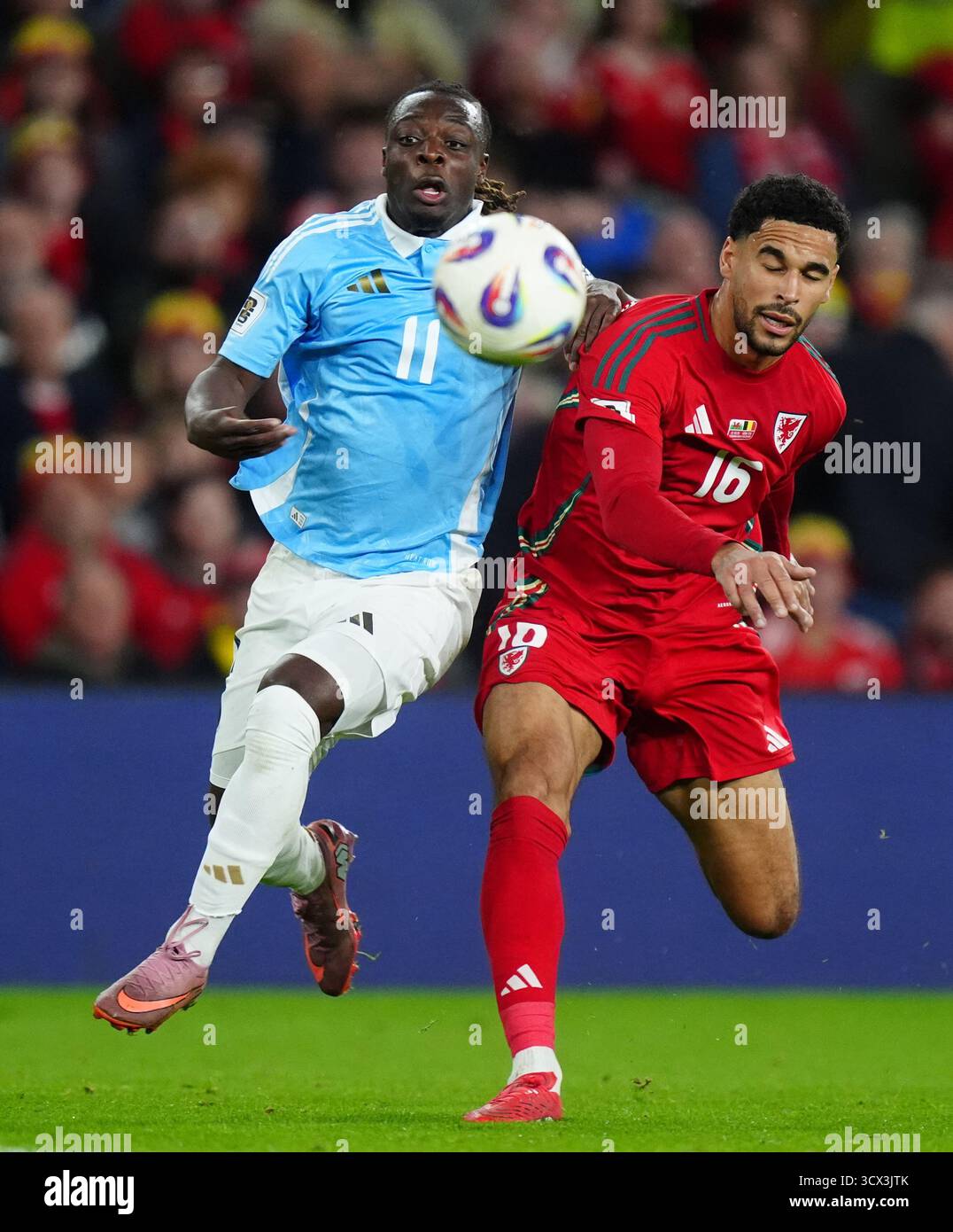 Belgium's Jeremy Doku (left) and Wales' Ben Cabango battle for the ball ...