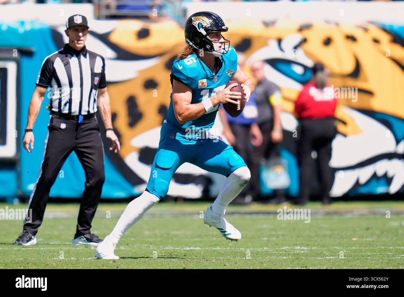 Jacksonville Jaguars quarterback Trevor Lawrence scrambles from the ...