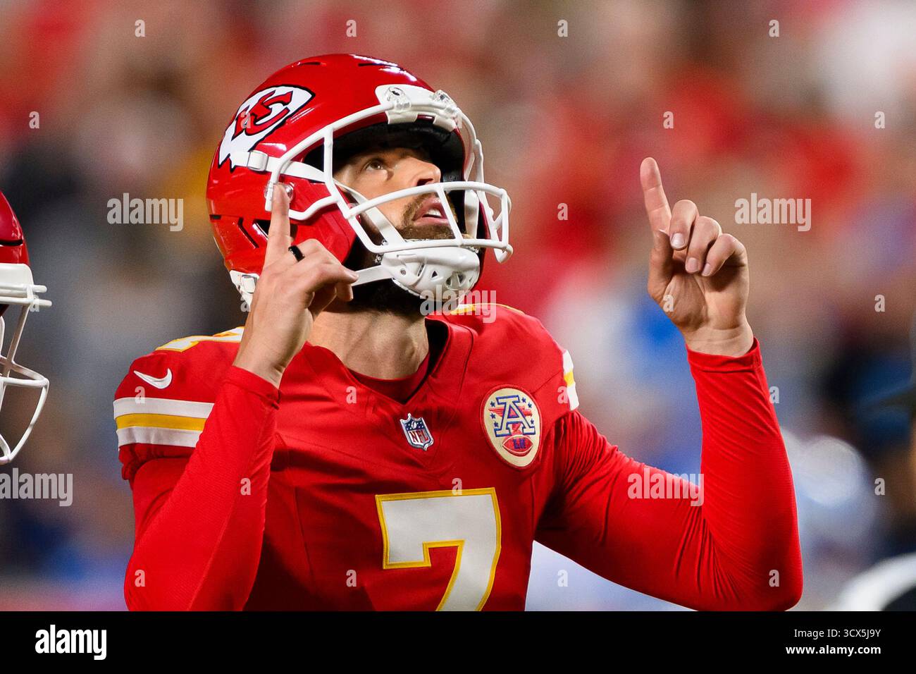 Kansas City Chiefs kicker Harrison Butker points to the sky after a ...