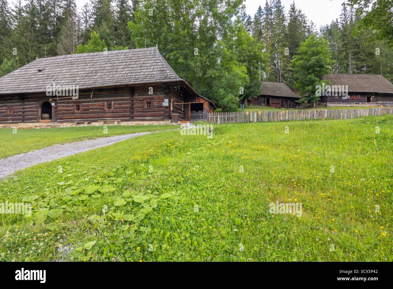 Old Slovakian log cabins with shingle roofs in a rural open air museum ...