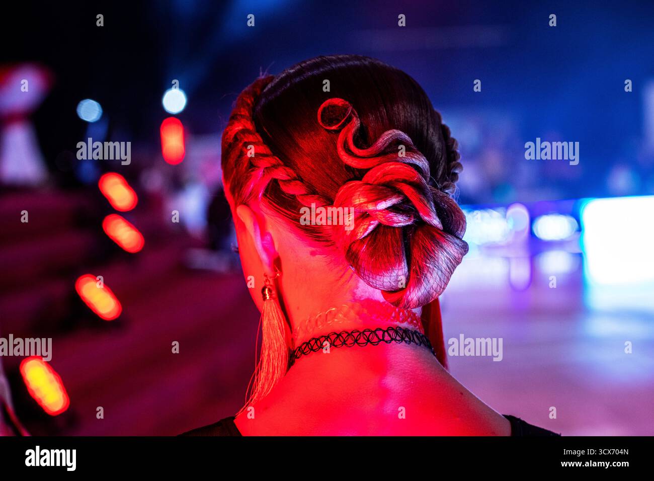 young dancer's beautiful bun hairstyle for a dance tournament with red ...
