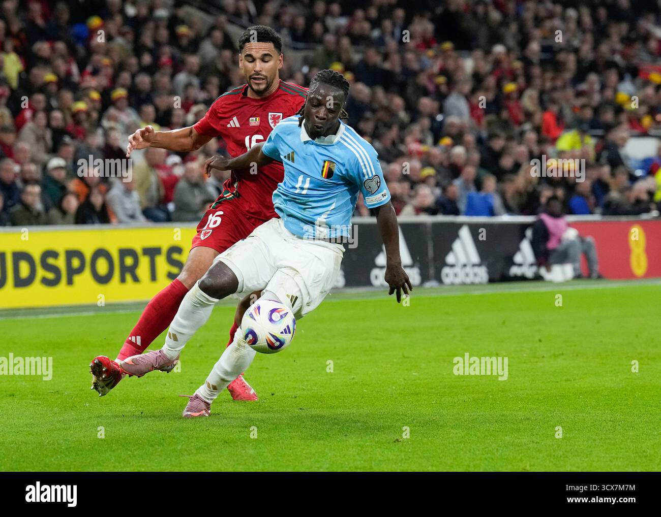 Cardiff,UK, 14 Oct 2025 Ben Cabango of Wales pressures Jeremy Doku of ...