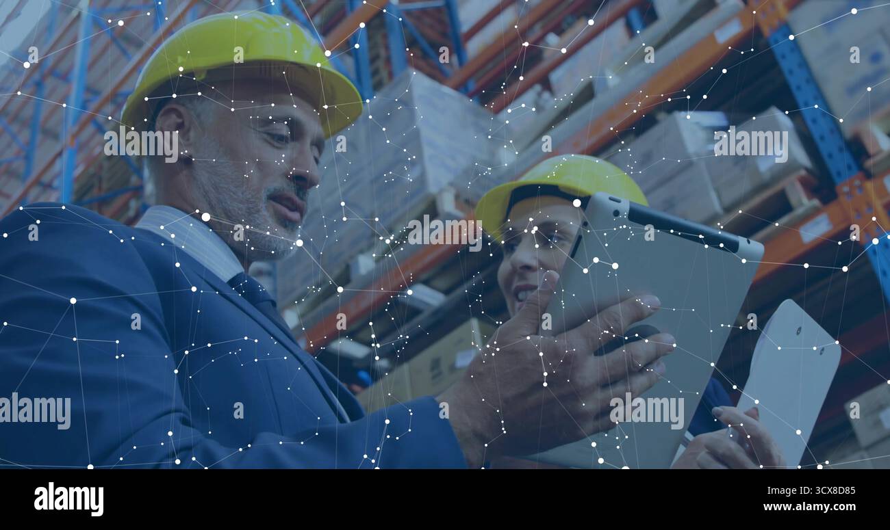 Professional warehouse team reviewing inventory hi-res stock ...