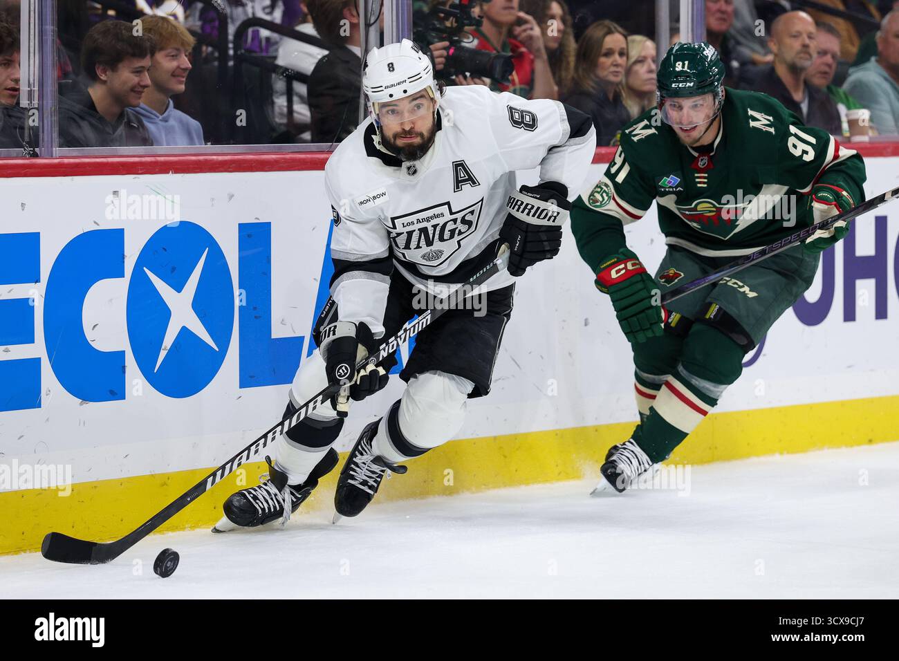 Los Angeles Kings defenseman Drew Doughty, left, skates with the puck ...