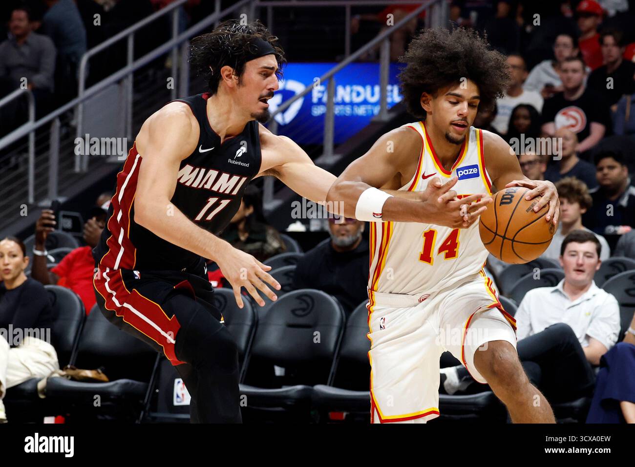 Atlanta Hawks forward Asa Newell (14) dribbles around Miami Heat guard ...