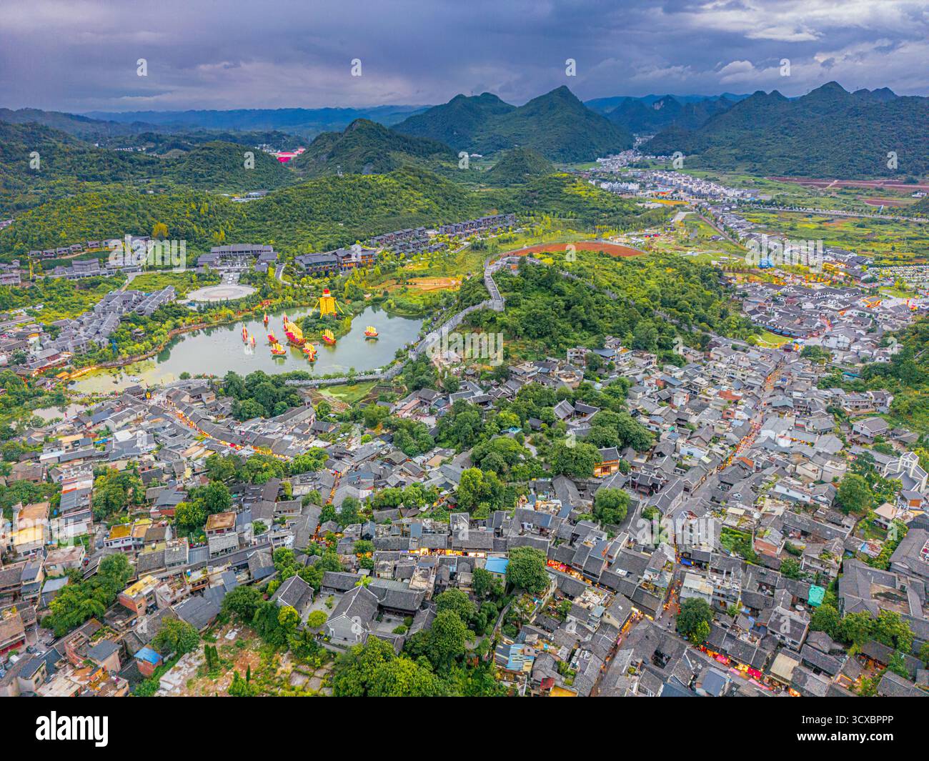 The pond with ships and streets of Qingyan Ancient Town, one of the top ...
