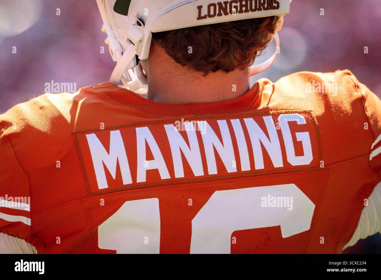 The last name of Texas quarterback Arch Manning is shown on his jersey as he warms up before an ...