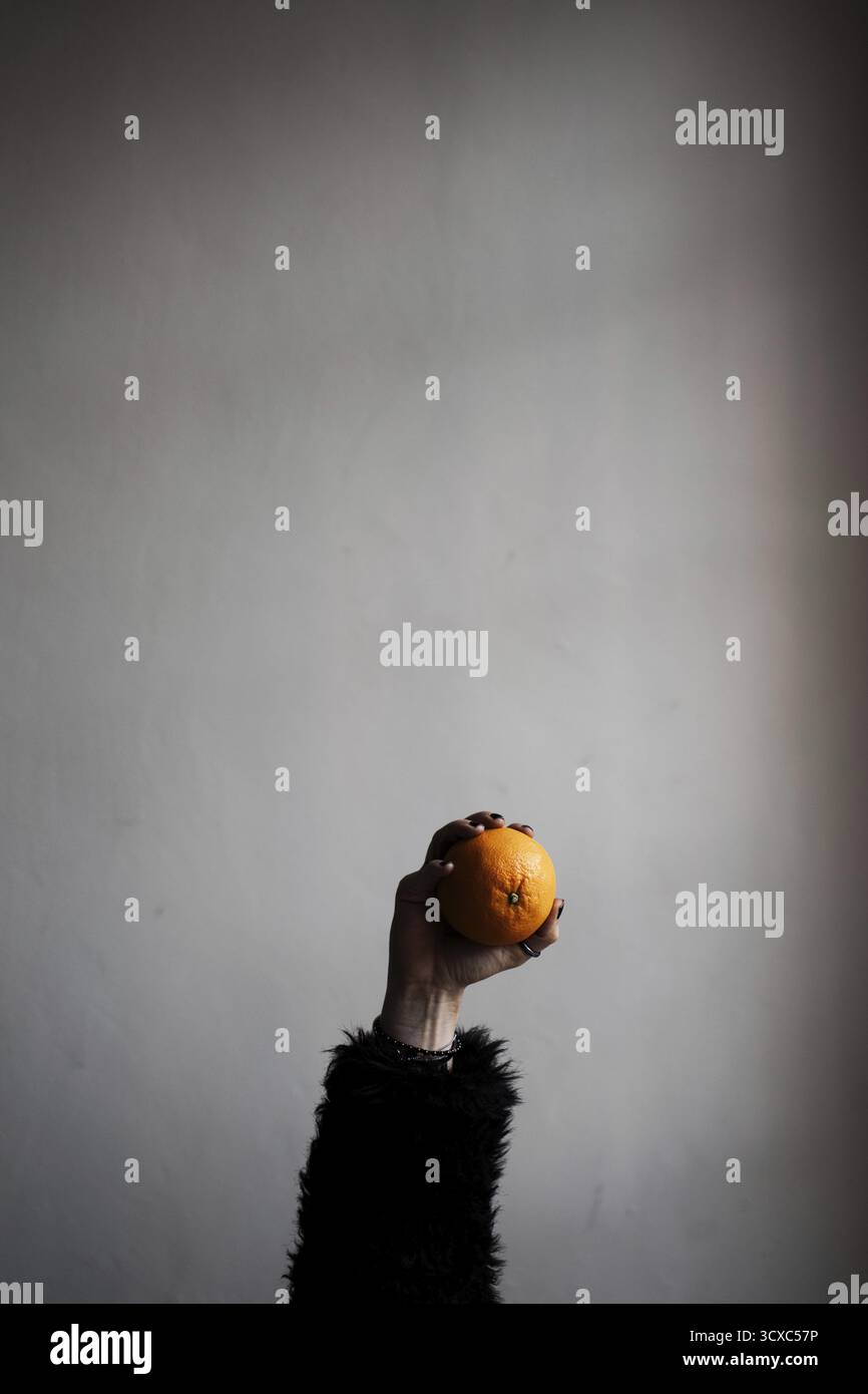 Picture human hand orange hi-res stock photography and images - Alamy