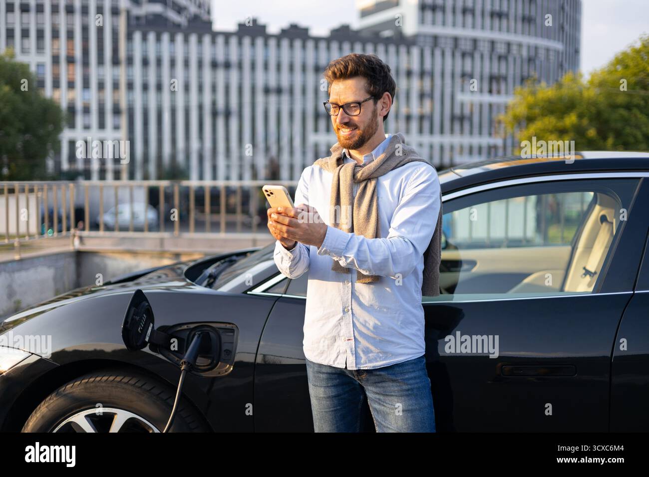 Electric car driver checking hi-res stock photography and images - Alamy