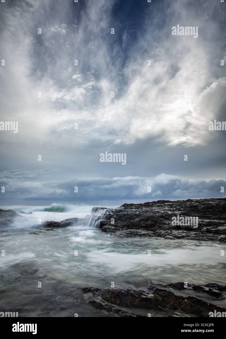 Rough seas crash against the rocky coast of Snapper Rocks, located on ...