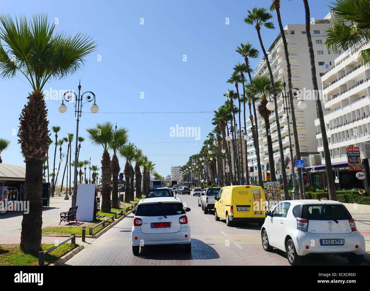 Sunny Beachfront Hotels And Modern Apartment Buildings Along Palm Lined ...