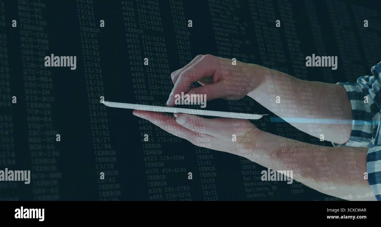 Tapping hands holding white tablet computer in dark workspace, with ...