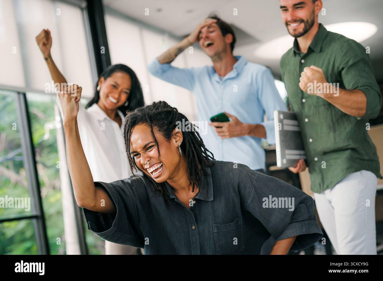 Joyful, excited diverse entrepreneurs are celebrating their success and ...
