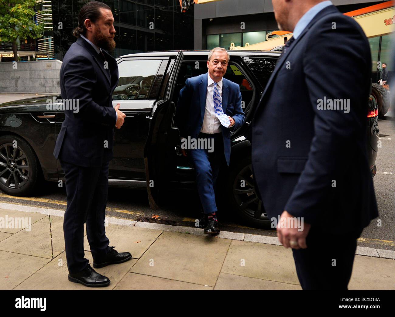 Nigel Farage (centre) arrives at Southwark Crown Court, south London ...