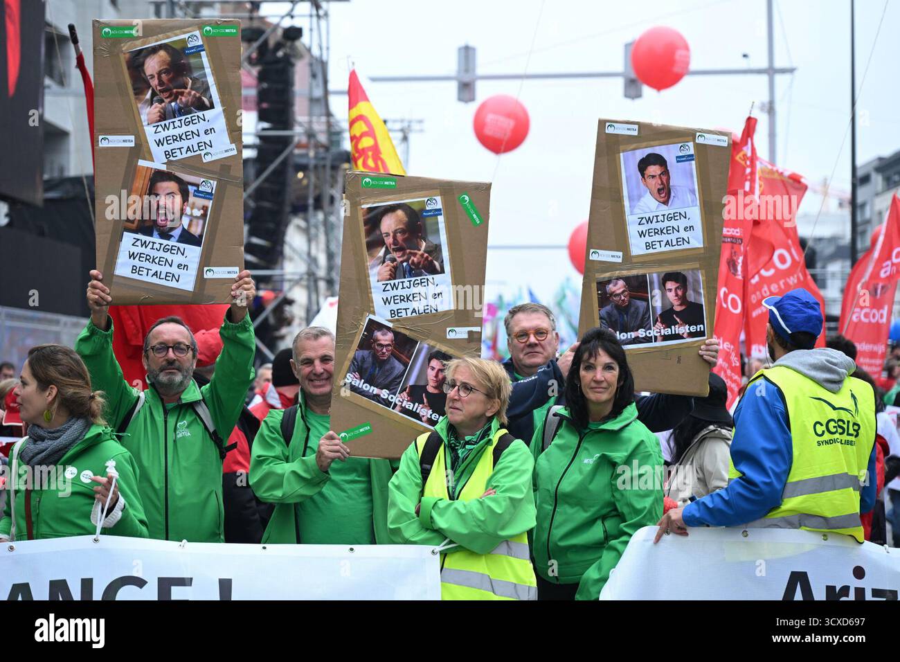 Demonstrators hold signs with photos of Belgian politicians which reads ...