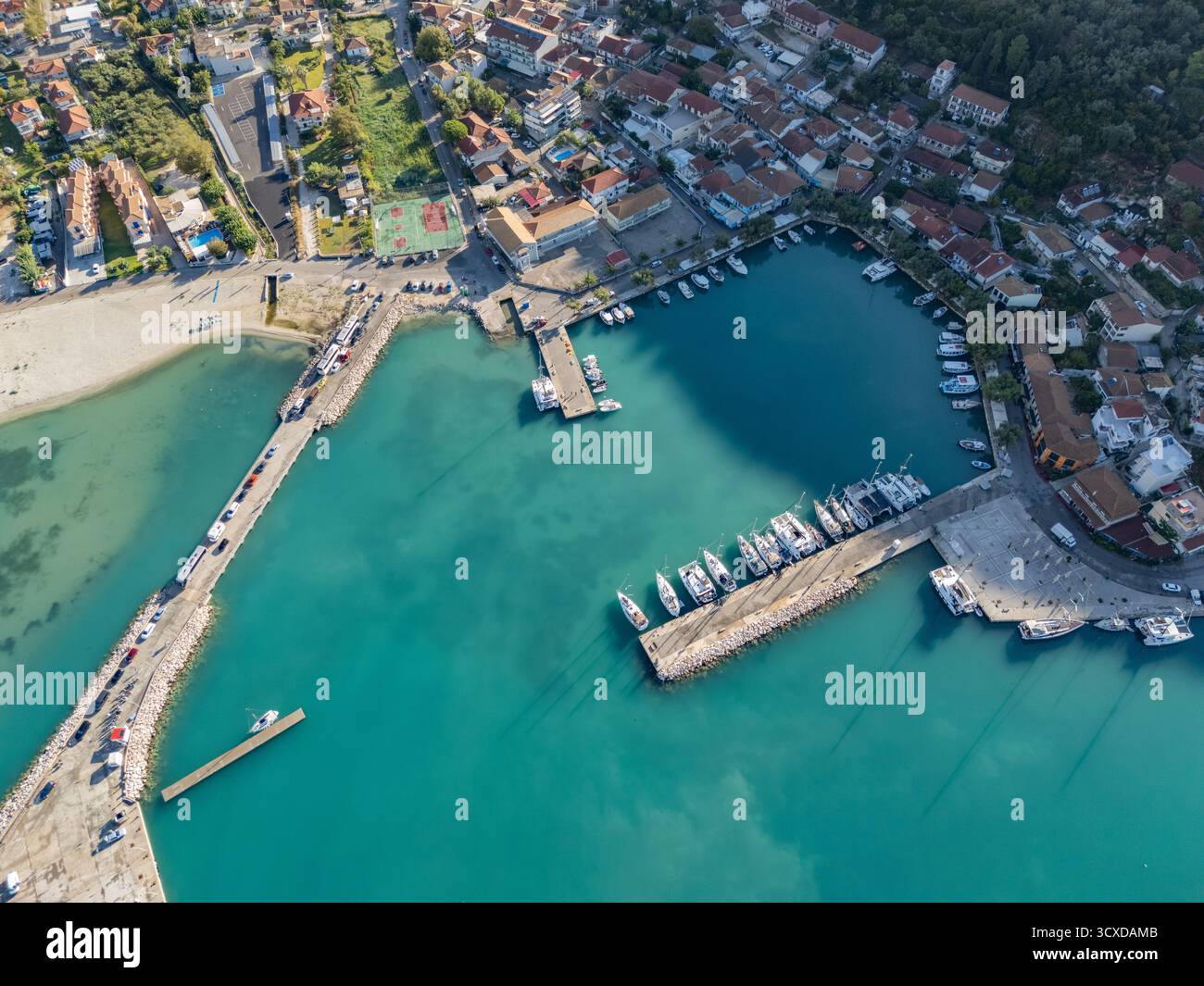 Aerial view of a vibrant harbor where turquoise waters meet the sandy ...