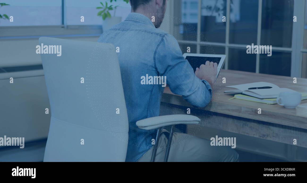 Man in denim tapping tablet hi-res stock photography and images - Alamy