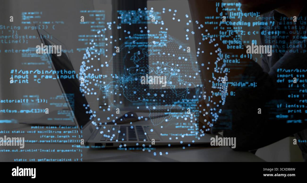 Developer wearing sweater typing code on laptop at desk, with ...