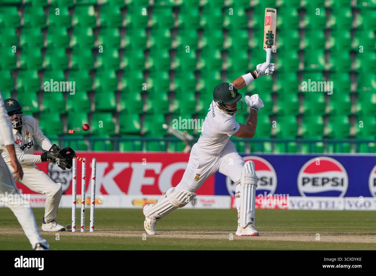 South Africa's Aiden Markram, right, is bowled out by Pakistan's Noman ...