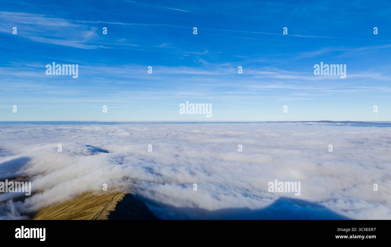 Mountain peaks emerge from a sea of clouds during a stunning cloud ...