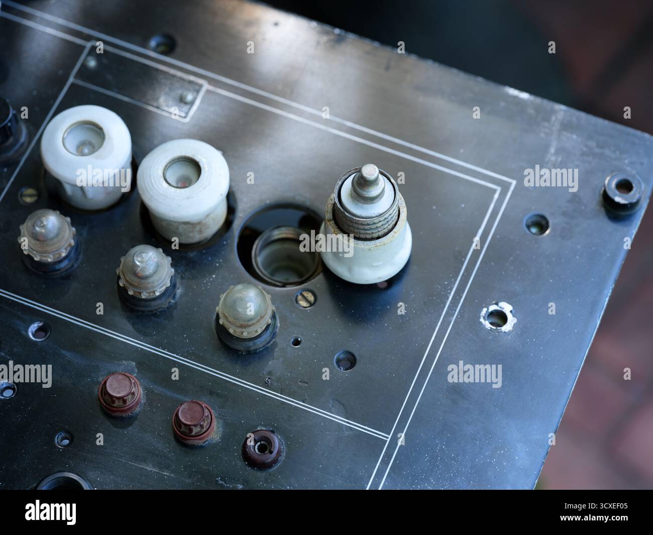 Old black electrical panel with white ceramic plug fuses and small ...