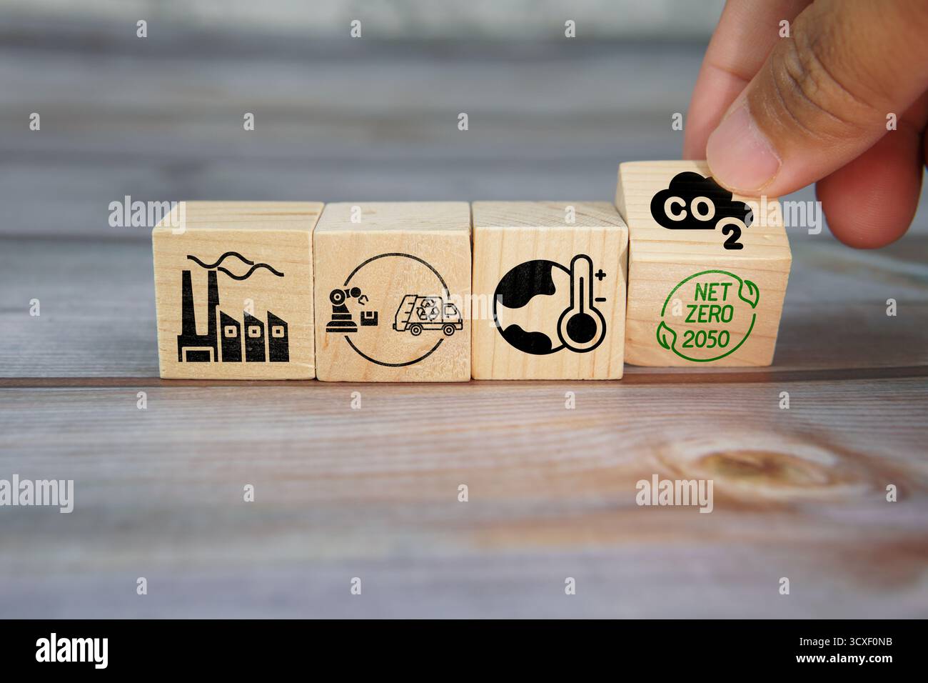 Wooden blocks with environmental icons showing factory emissions ...
