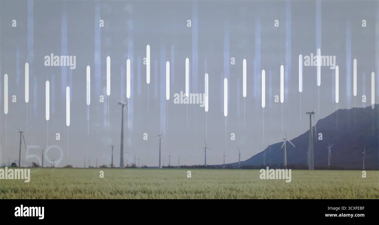 Spinning white wind turbines rotating across green field at mountain ...
