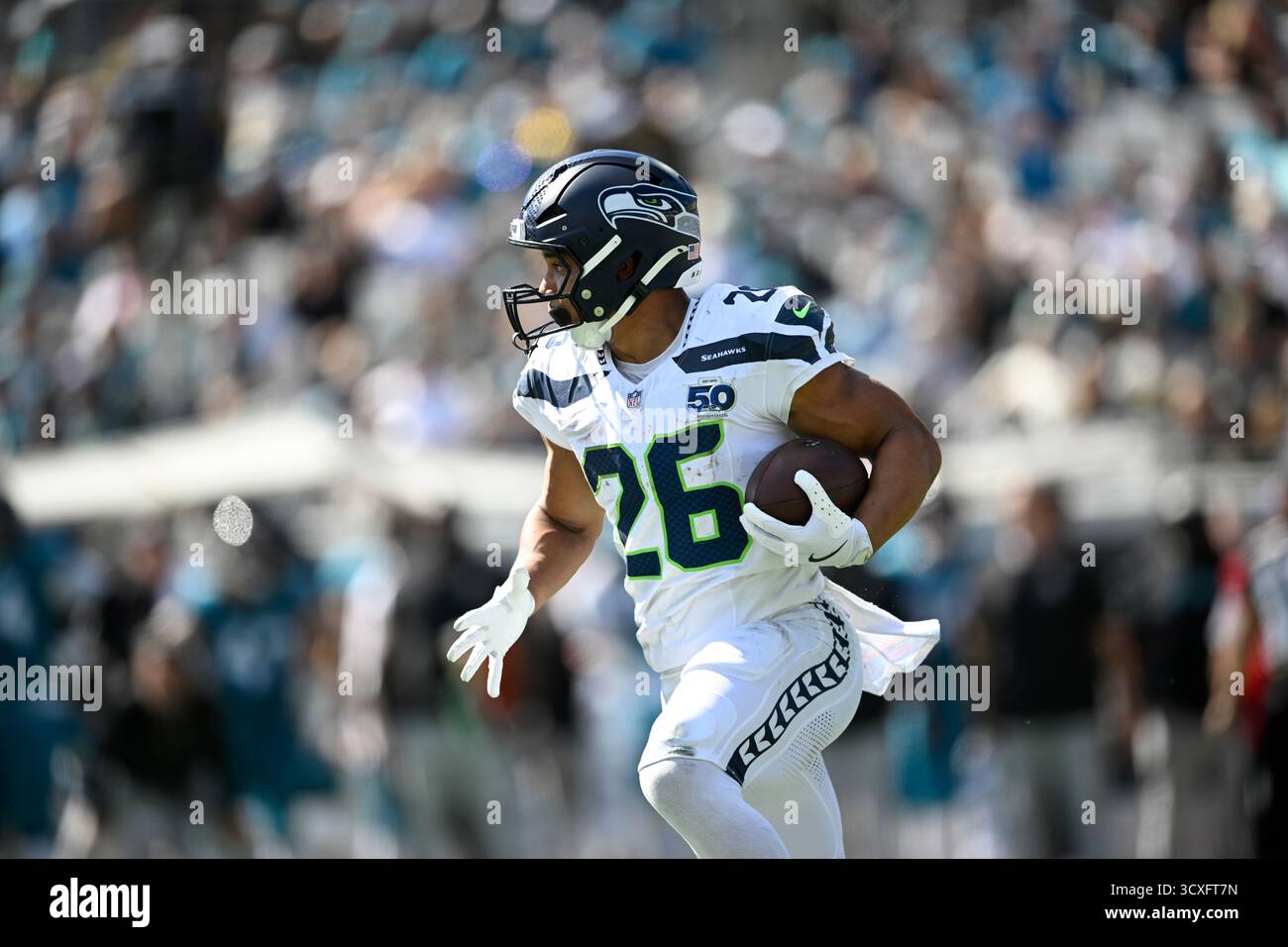 Seattle Seahawks running back Zach Charbonnet (26) rushes for yardage ...