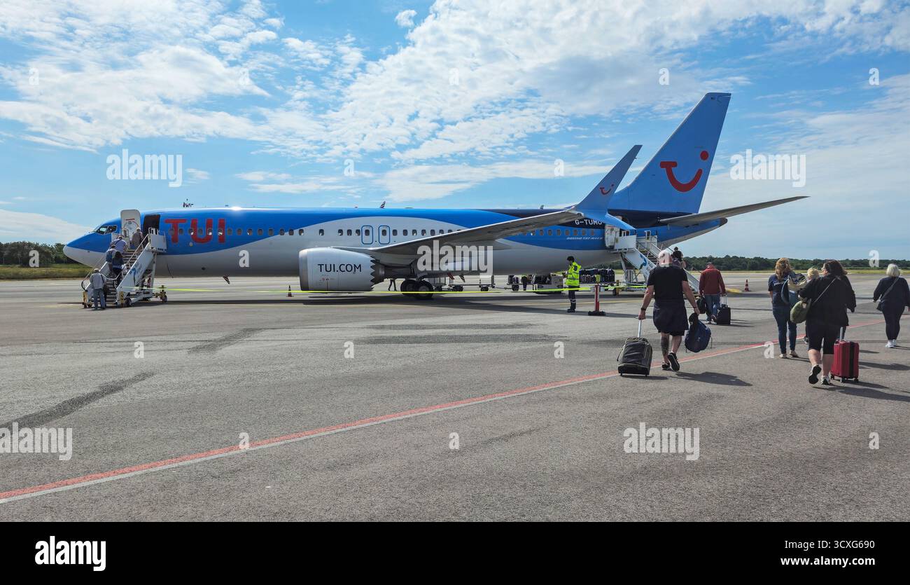 Passengers boarding a Boeing 737 MAX 8 airplane, aeroplane or aircraft ...