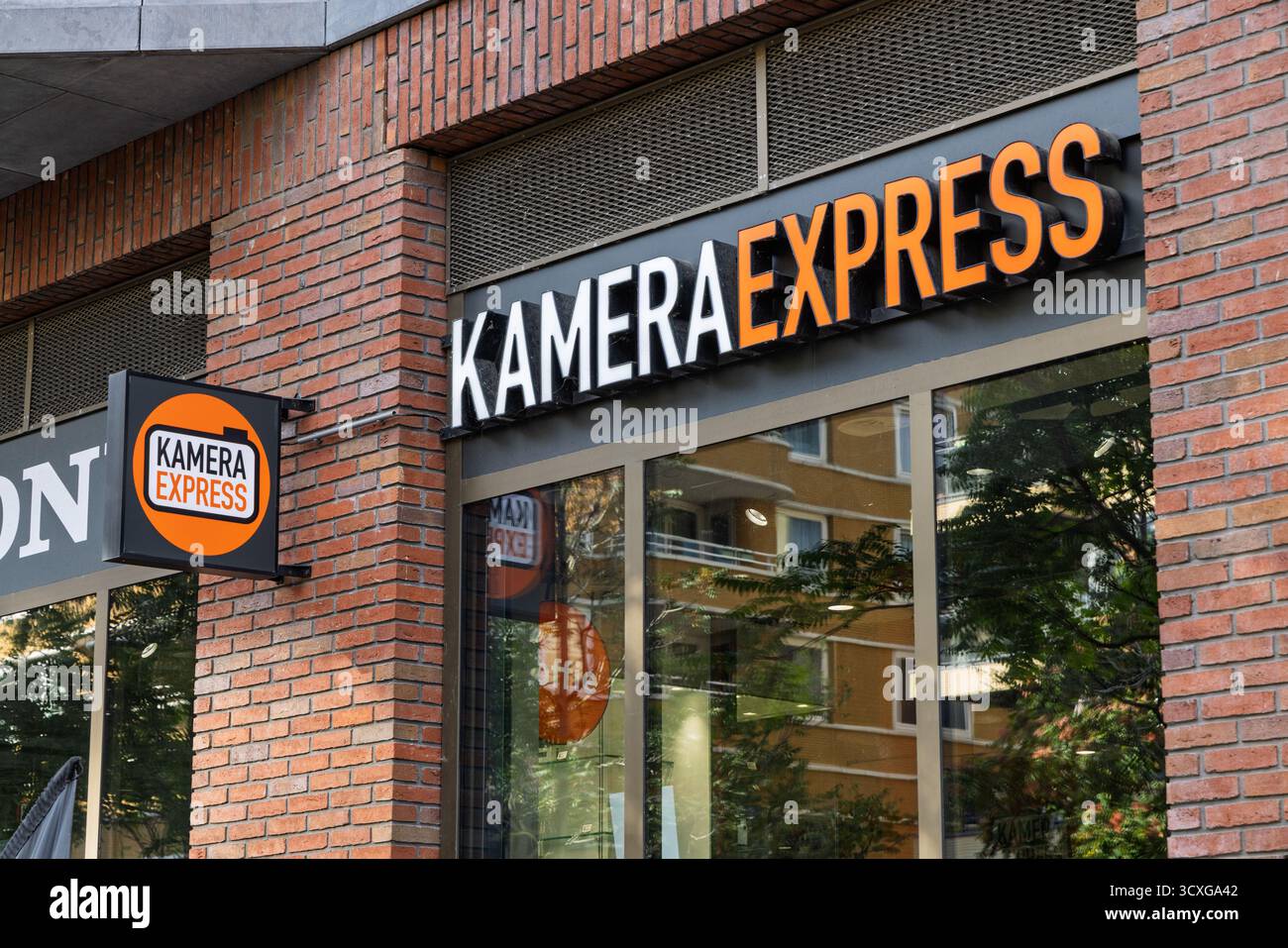 Close-up of the Kamera Express logo and signage, featuring orange and ...
