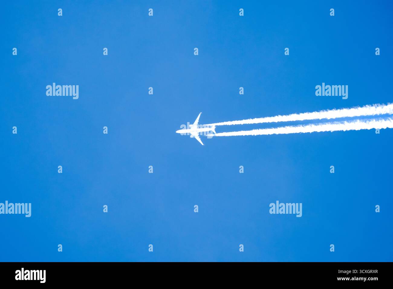 twin engined jet liner aircraft with contrails, in flight at high ...