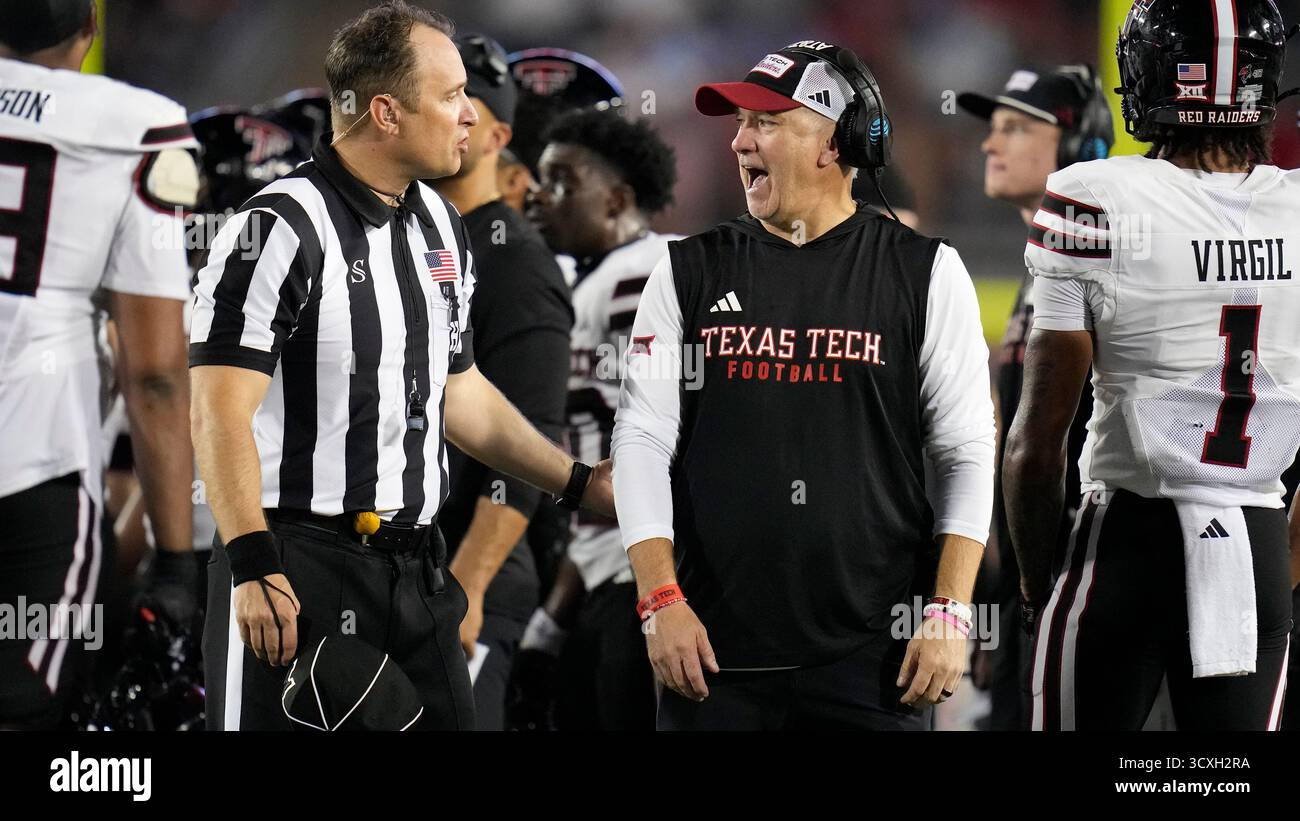 Texas Tech head coach Joey McGuire speaks to Head linesman Matt Burks ...