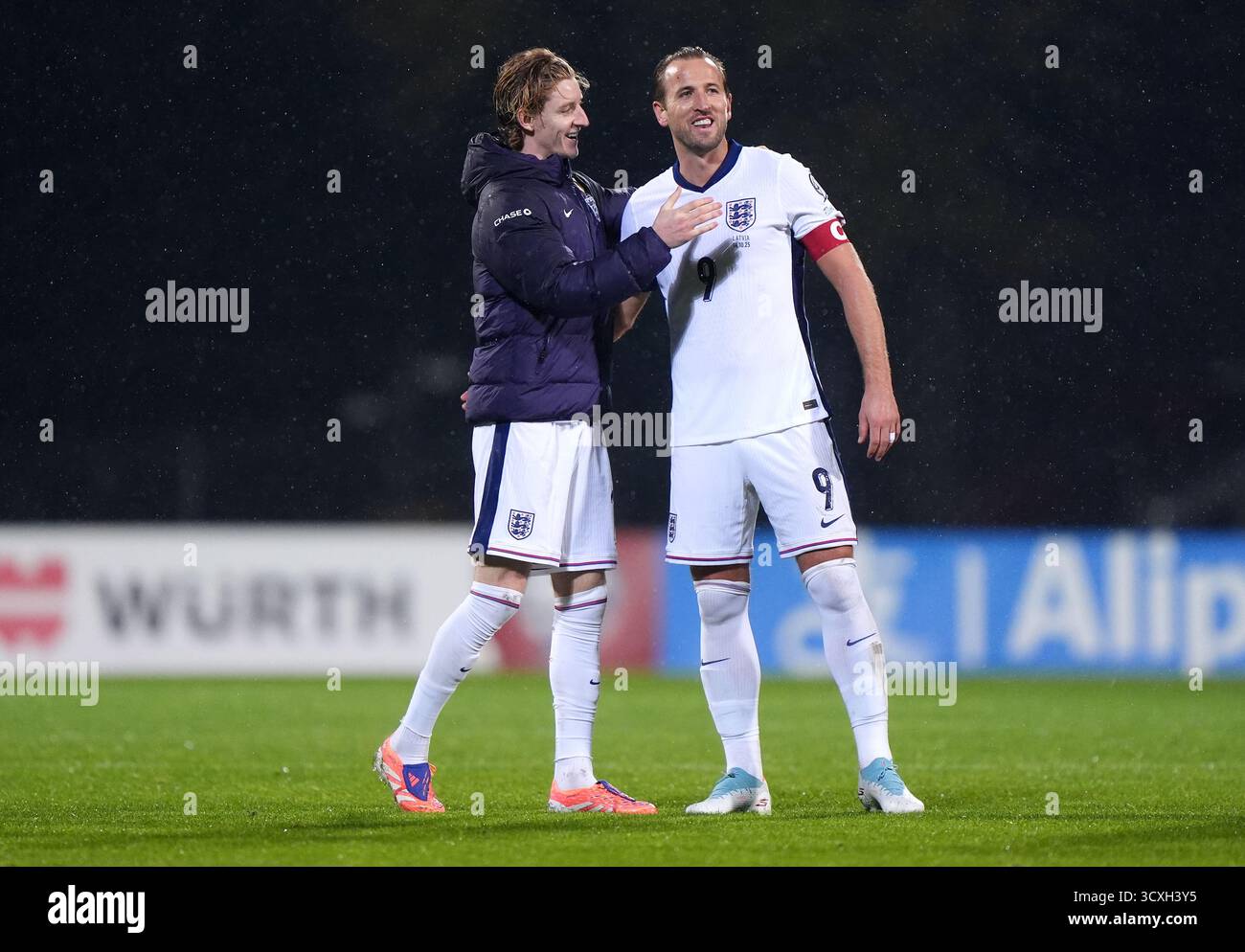 England's Harry Kane (right) shake hands with team-mate Anthony Gordon ...